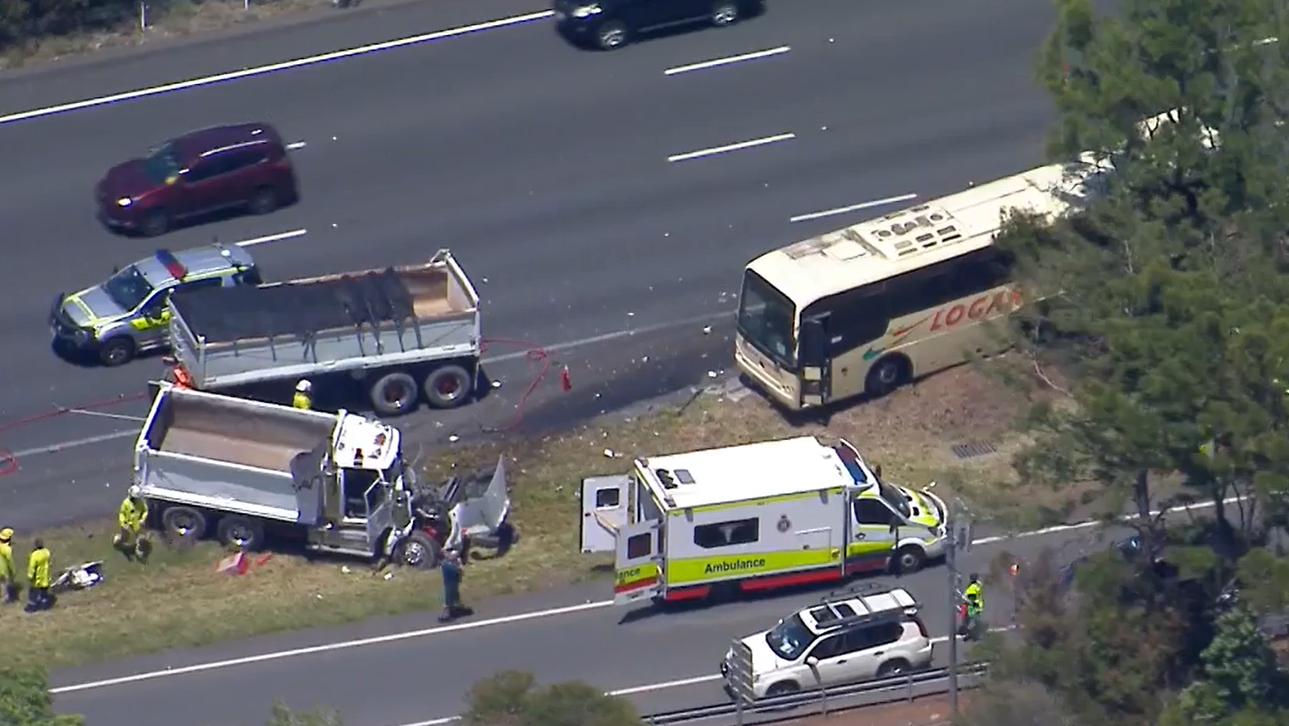 Lengthy delays on M1 as dozens involved in crash between bus and truck
